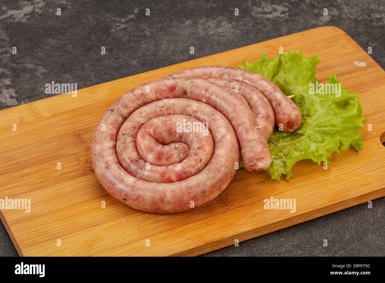 Raw pork sausage ring for grill Stock Photo - Alamy