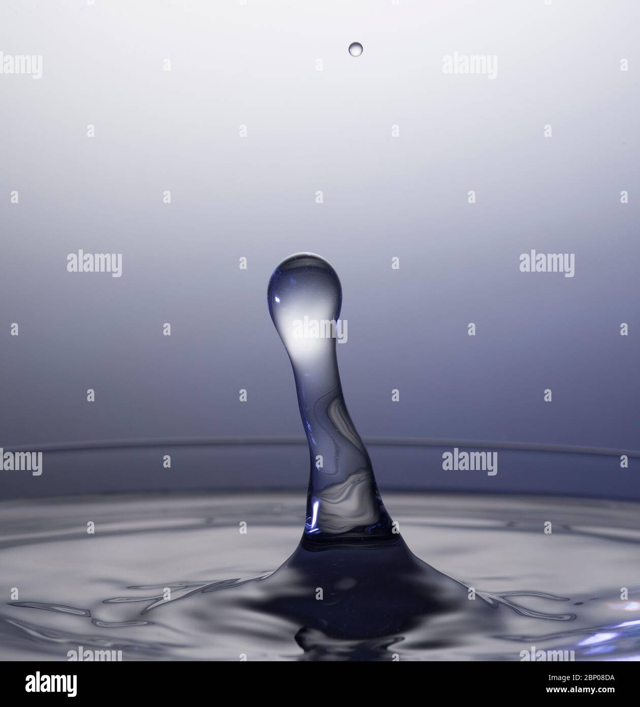Water droplets forming a column, photographed at high speed to freeze ...