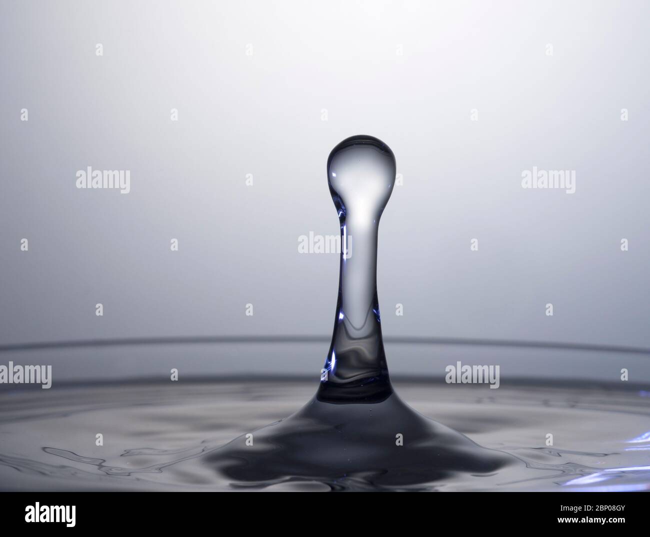 Water droplets forming a column, photographed at high speed to freeze ...