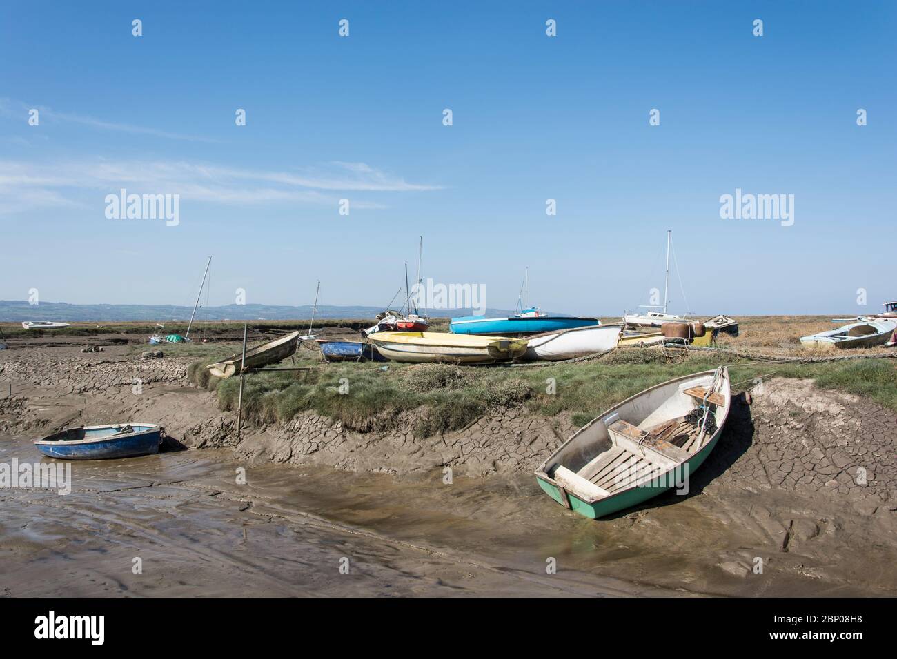 Beached boats waiting the tide on marshland at Lower Heswall boatyard ...