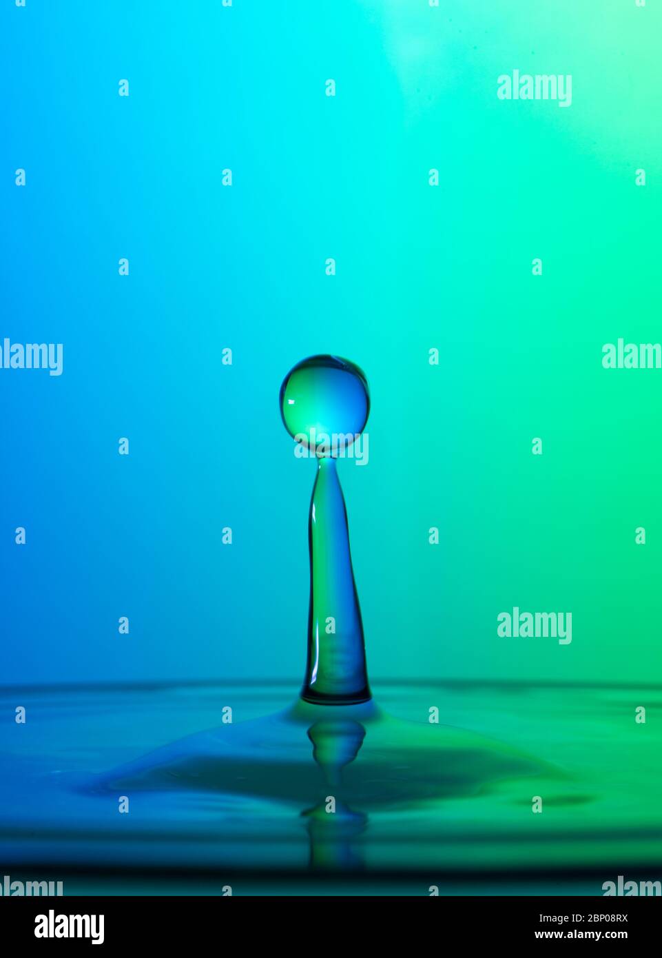 Water droplets forming a column, photographed at high speed to freeze ...