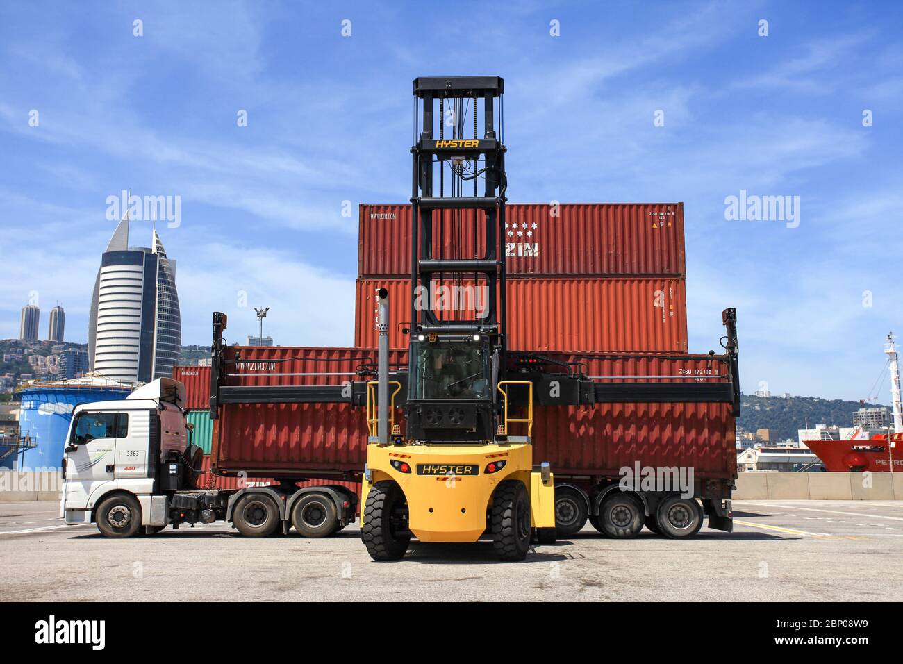 Hyster Container handler lifting a Shipping container in a local port ...
