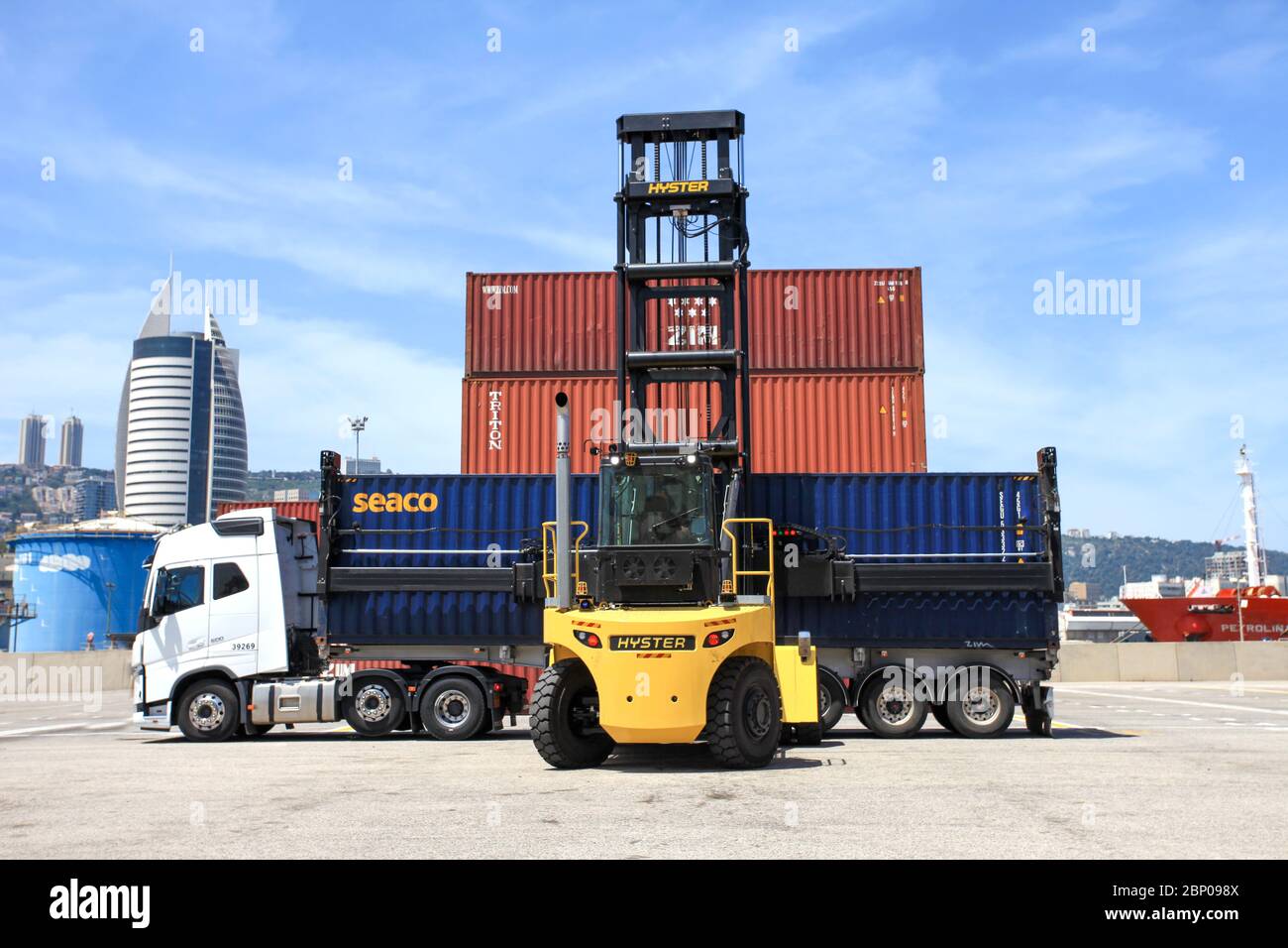 Hyster Container handler lifting a Shipping container in a local port ...