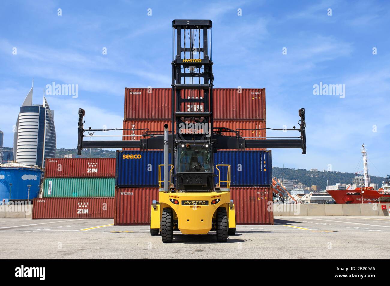 Hyster Container handler lifting a Shipping container in a local port ...
