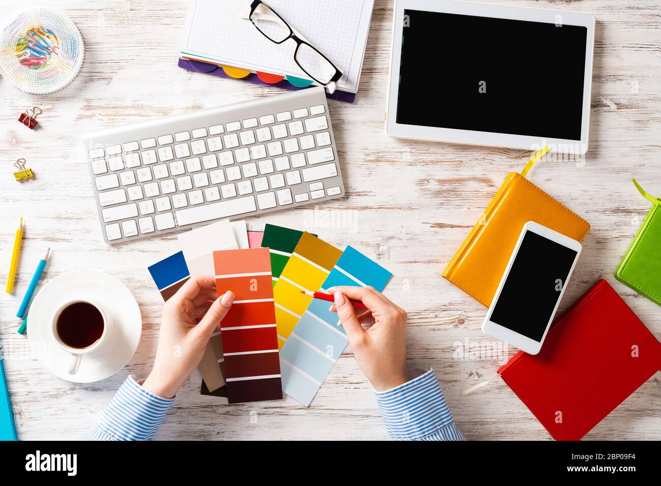 Web designer choosing colors from swatches Stock Photo - Alamy