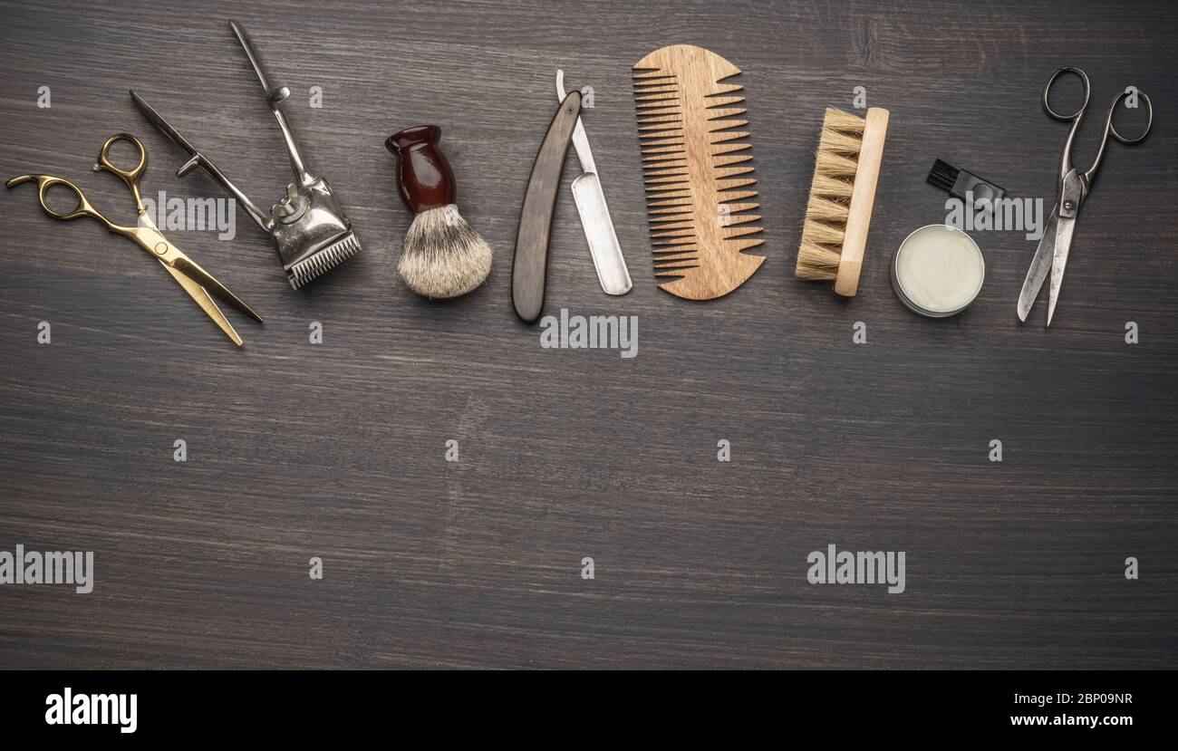 Classic grooming and hairdressing tools on wooden background. Top view ...