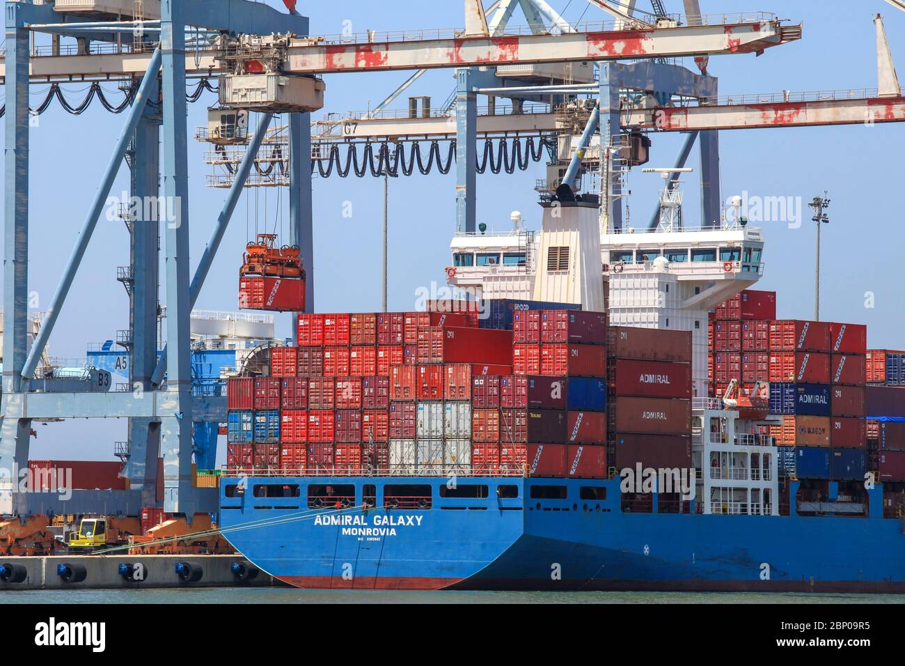 Large Container Ship docked at a commercial port during loading and ... Large Container Ship docked at a commercial port during loading and ...