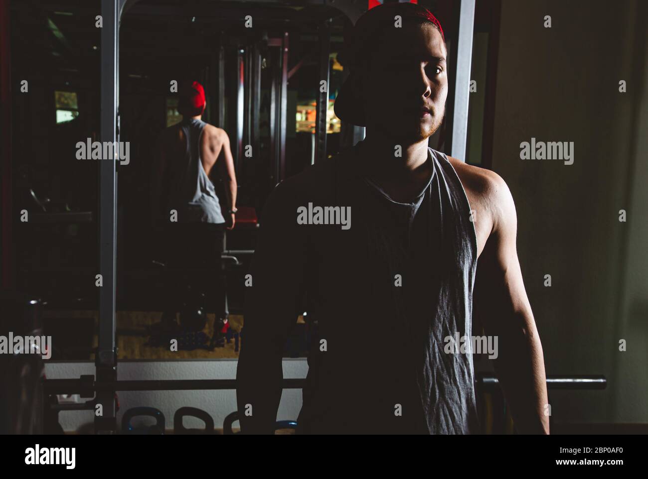 Strength training of a muscular young athlete in the gym. Stamina and ...