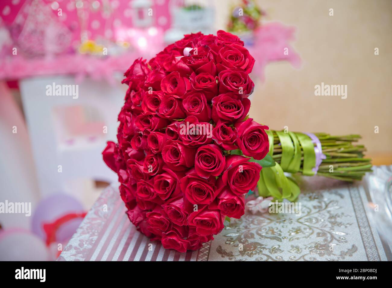 Big bouquet of one hundred big red roses flowers on the table . A ...
