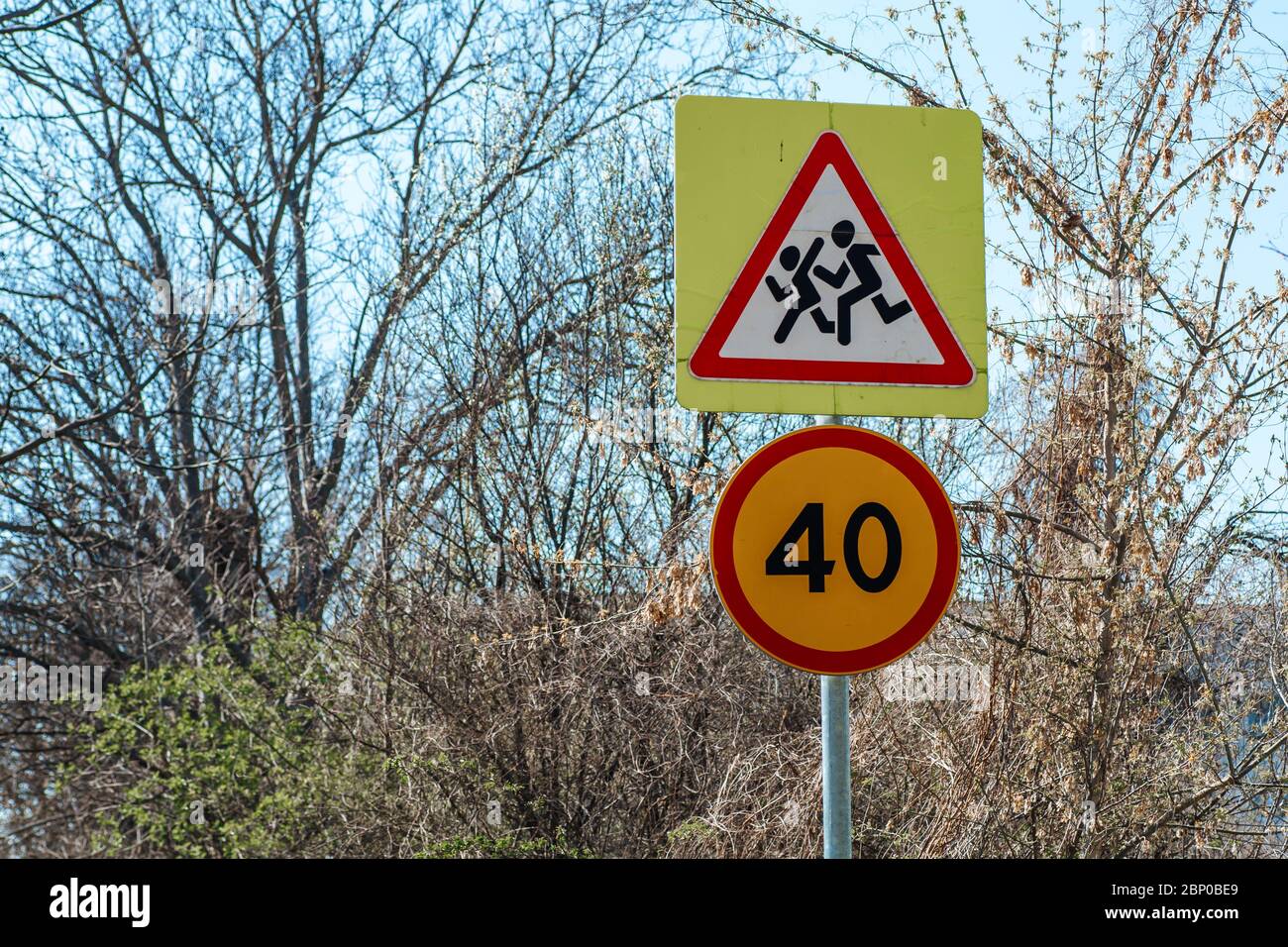 Road sign Caution children and speed limit 40 on the background of ...