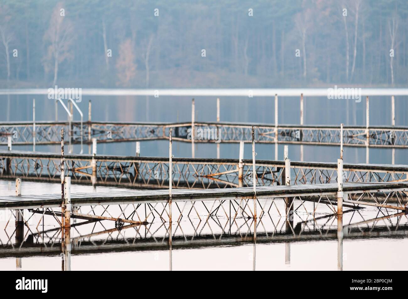 Old metal and wooden, a bit rusty platforms on the lake. Wooden piers ...