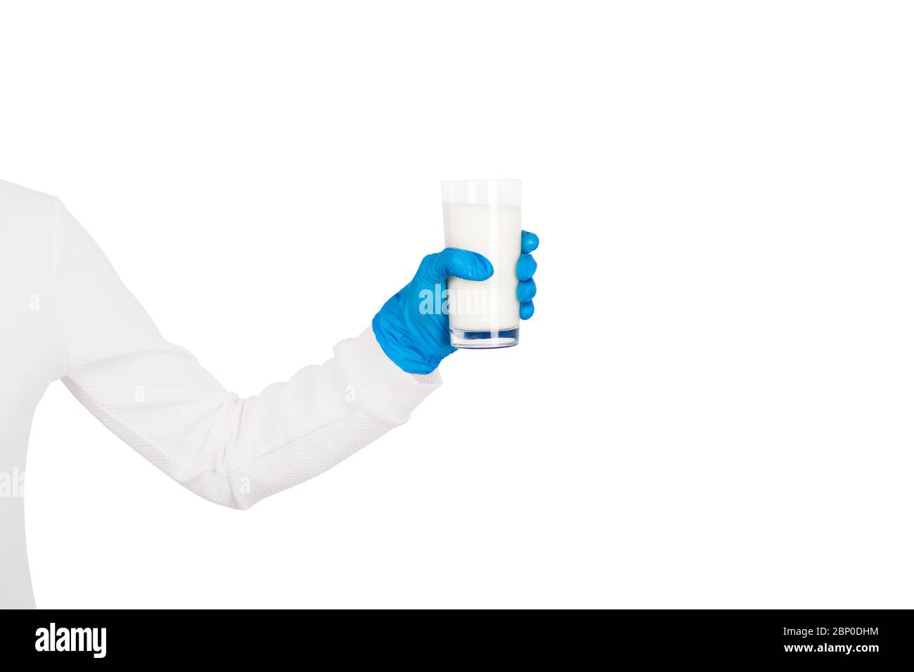 Female hand in disposable glove holds glass of milk or yogurt. Hygiene ...