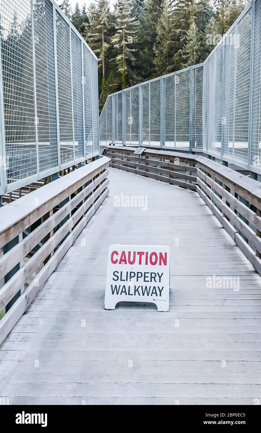 caution slippery walkway warning sign on the walk way cover with the ...