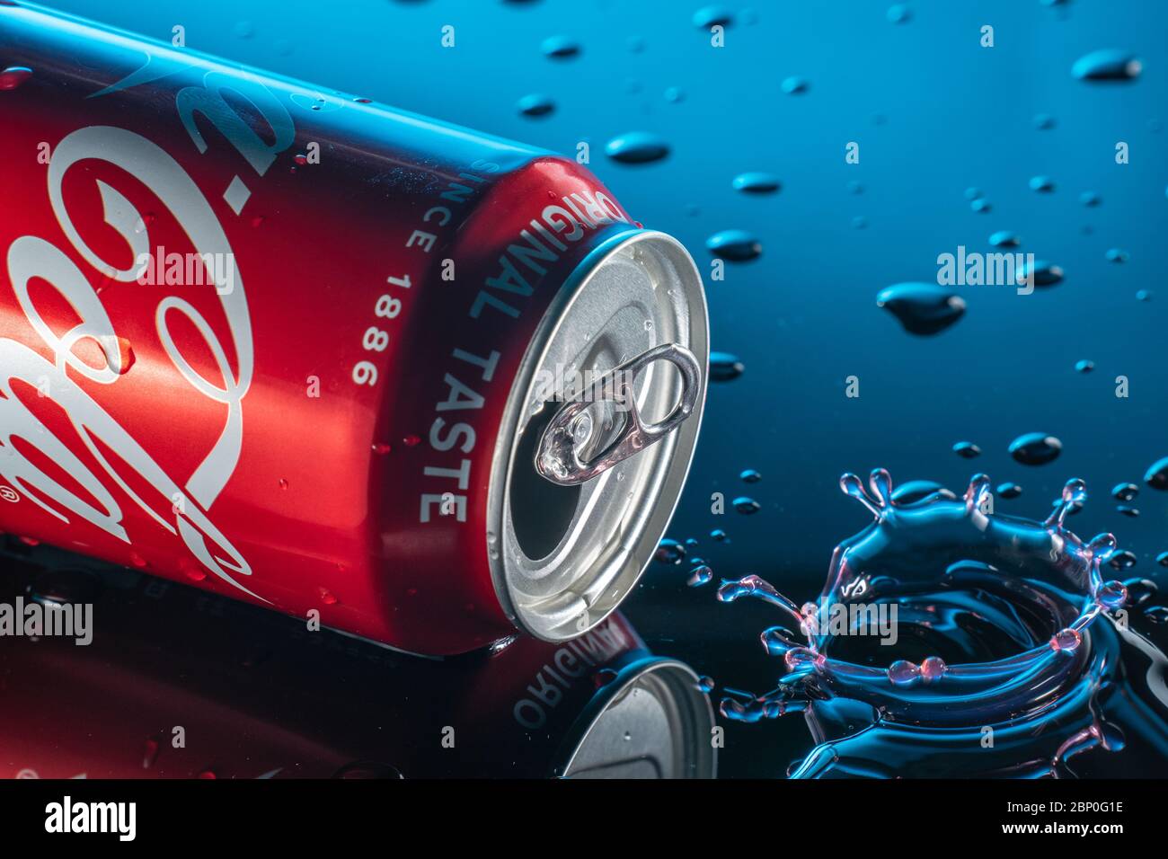 Bedford,UK,May 16,2020. Coca Cola can with splashes of water on a black ...