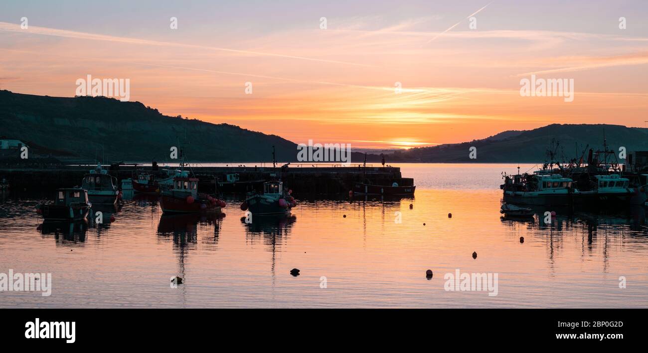 Lyme Regis, Dorset, UK. 17th May, 2020. UK Weather: The sun rises over ...