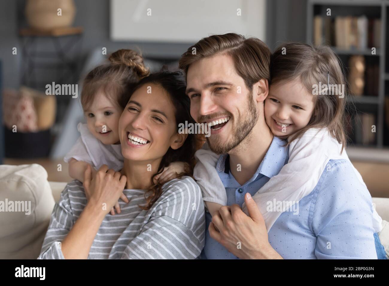 Happy family with little kids hug at home Stock Photo - Alamy