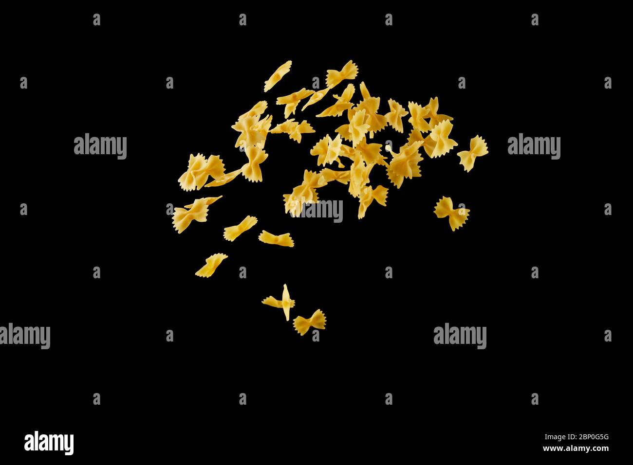 Italian flying raw pasta isolated on black background. macaroni ...