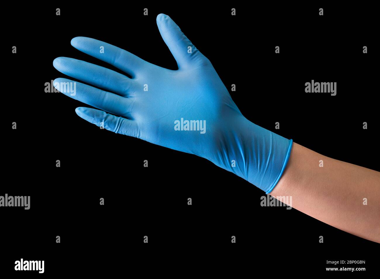 Doctor's hand in sterile medical gloves showing palm isolated on black ...