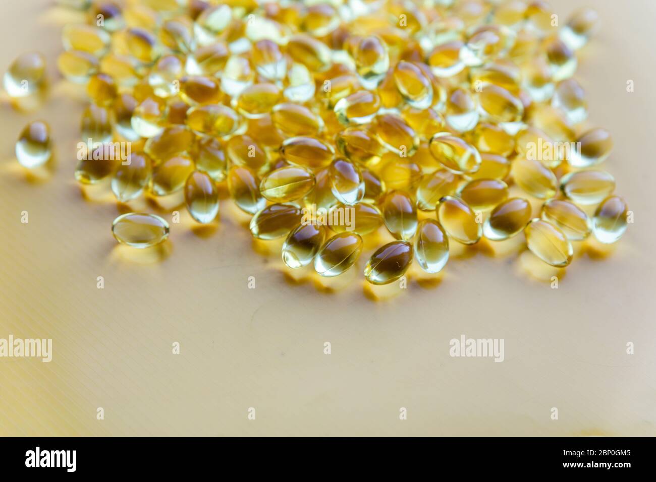 Heap of yellow vitamin supplements, omega 3 capsules, health dietary on ...