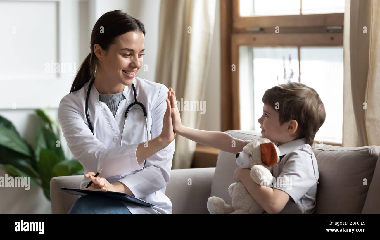 Smiling female doctor give high five greeting with small patient Stock ...