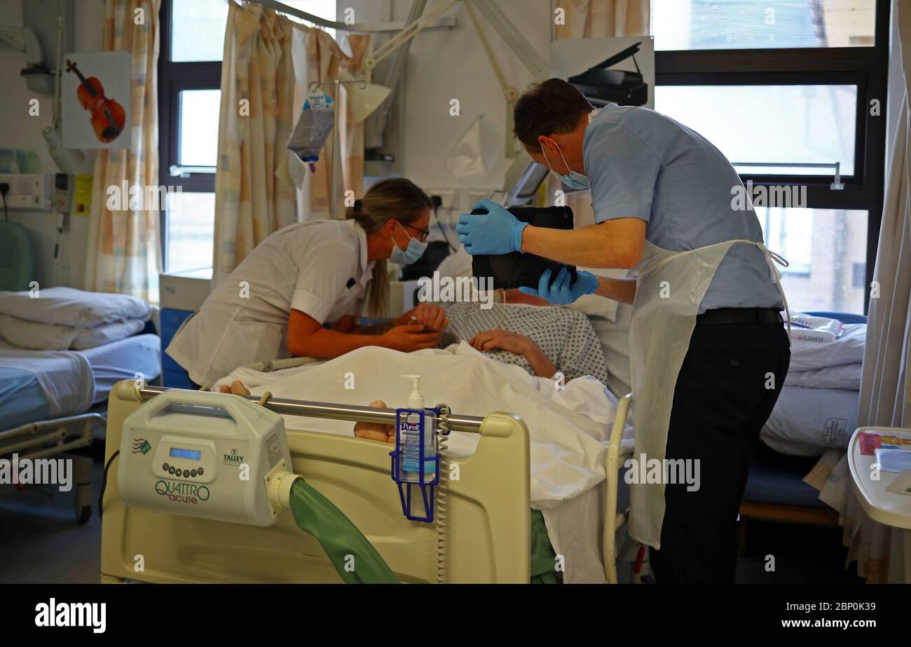 Chaplain David Anderson and student nurse Kadie Laycock help a patient ...