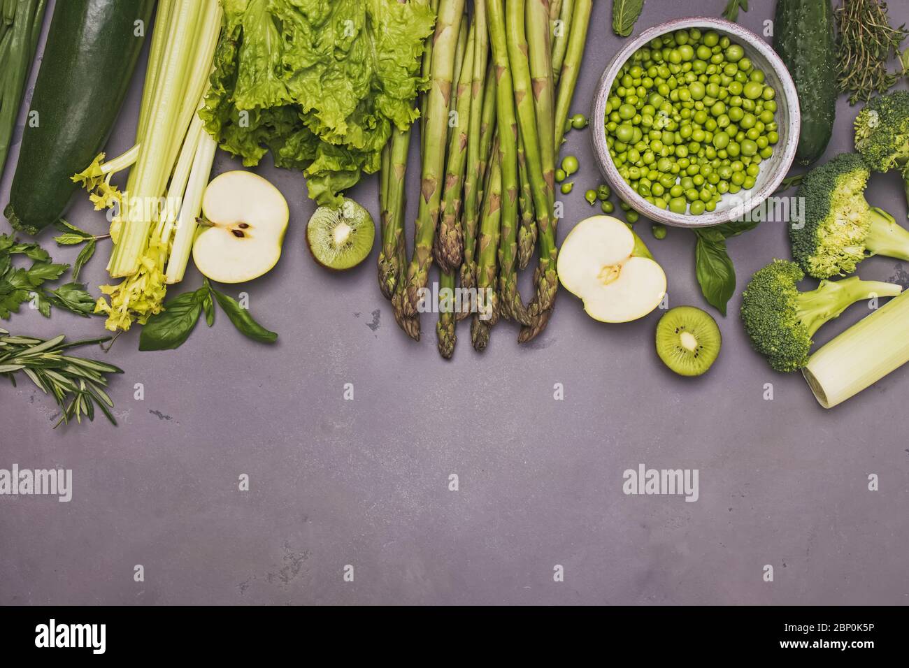 Fresh organic spring vegetables and spices on grey stone table Stock ...
