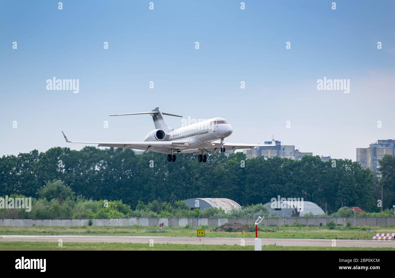 Business jet on final approach before landing on the runway Stock Photo ...