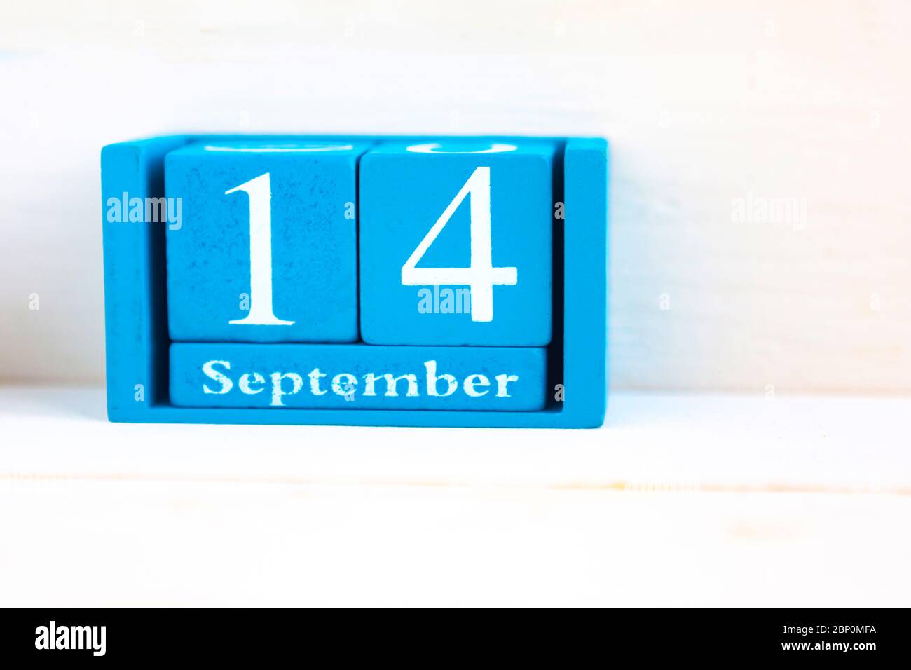 September 14, wooden background. Handmade wooden cube calendar with ...