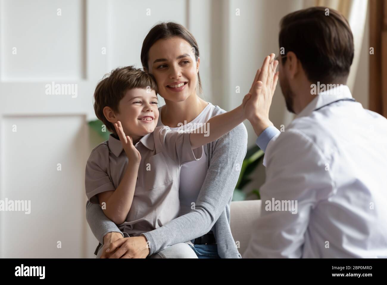 Happy little boy patient greeting with pediatrician at checkup Stock ...