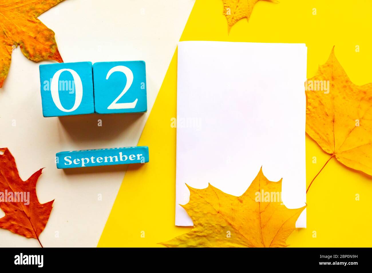 September 2, empty yellow and white geometric background. Wooden ...