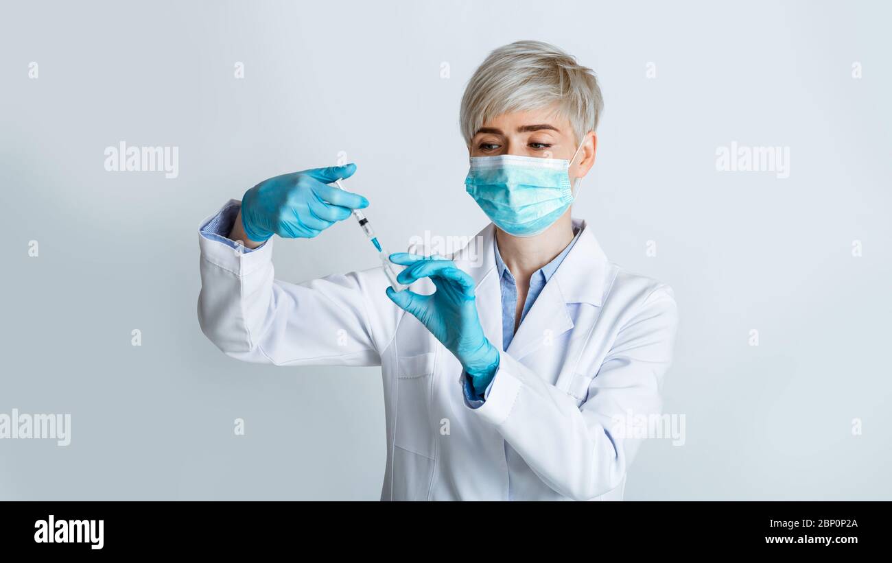 Doctor picks up syringe coronavirus hi-res stock photography and images - Alamy