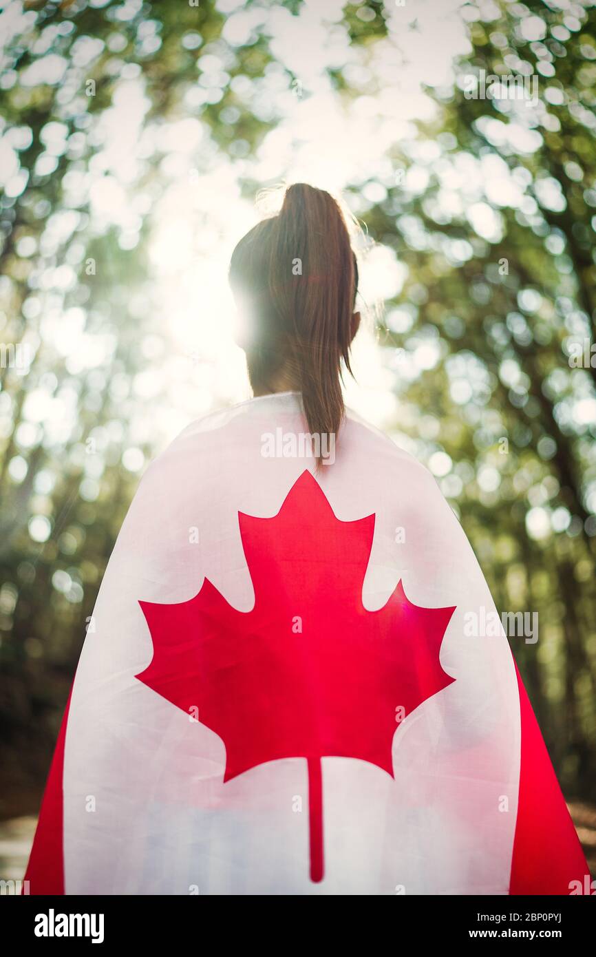 Child teenager girl at nature background an Canada flag on her ...