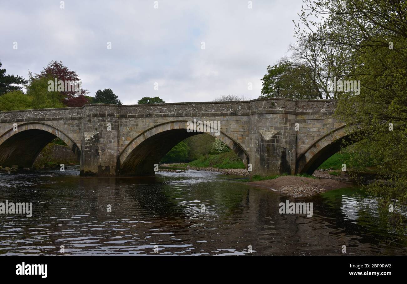 River with a stone bridge that has arches Stock Photo - Alamy