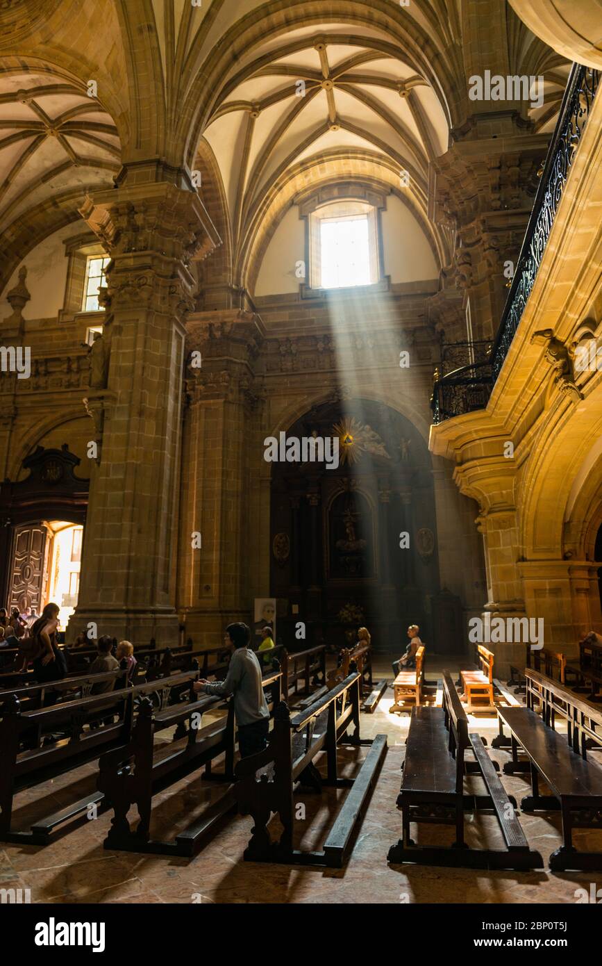 People praying in the pews of the church of Santa Maria , Gipuzkoa ...