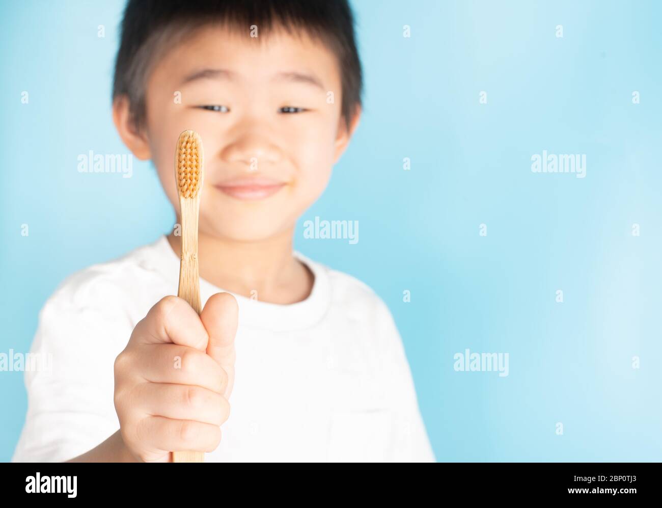 An Asian child is holding a toothbrush. To show the preference of care ...