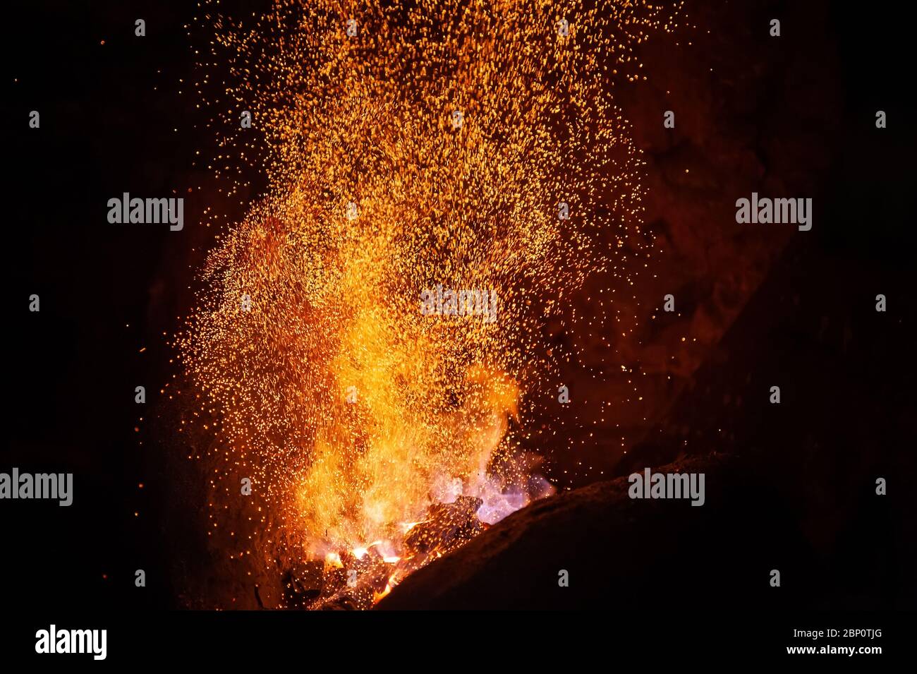 Smithy fire flame tips with sparks closeup on dark background Stock ...