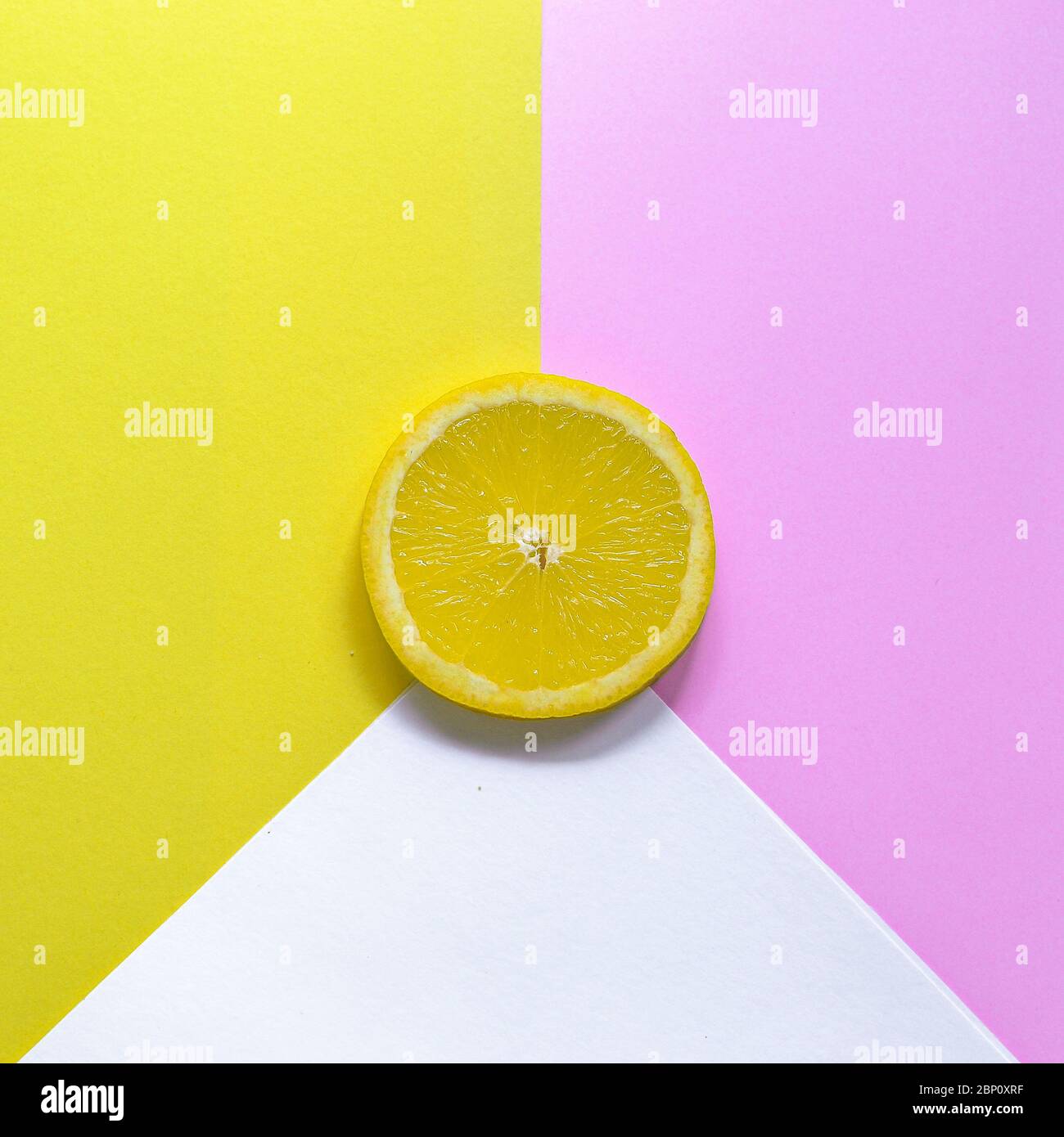 Minimal food concept. Lemon on a bright yellow-pink background. Free ...