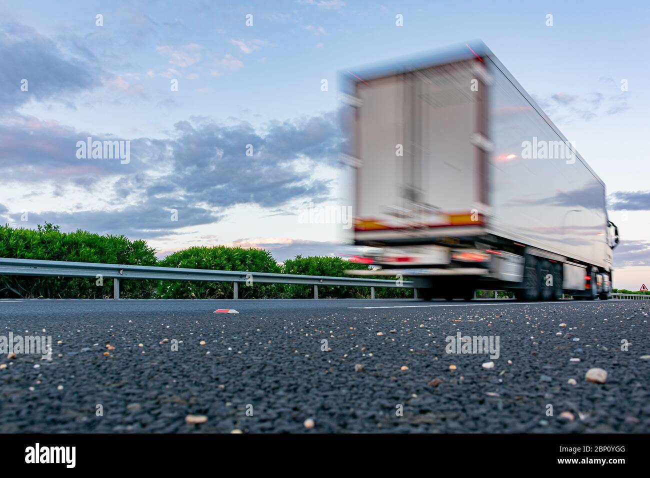 Moving truck driving on the highway at high speed Stock Photo - Alamy