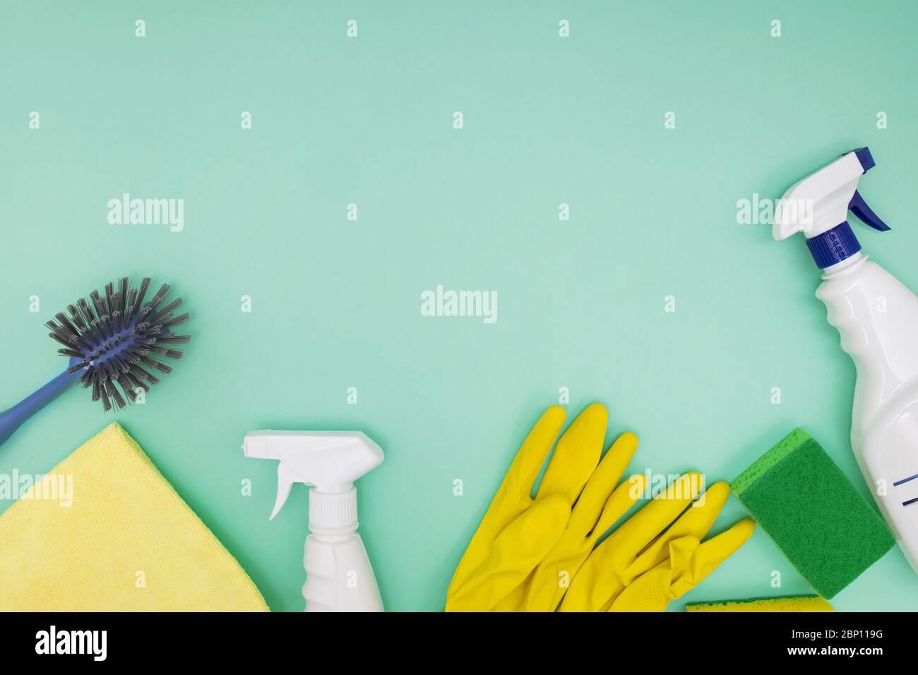 Cleaning tools and supplies on green background, top view Stock Photo ...