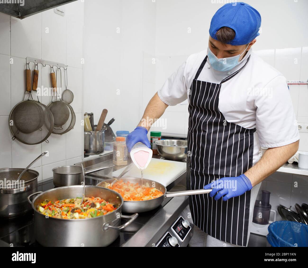 Person frying vegetables cooking hi-res stock photography and images ...