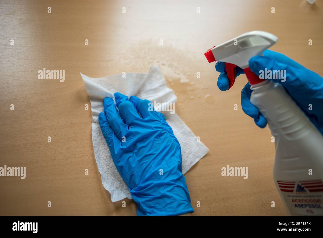 Cleaning home office table sanitizing kitchen table surface with ...