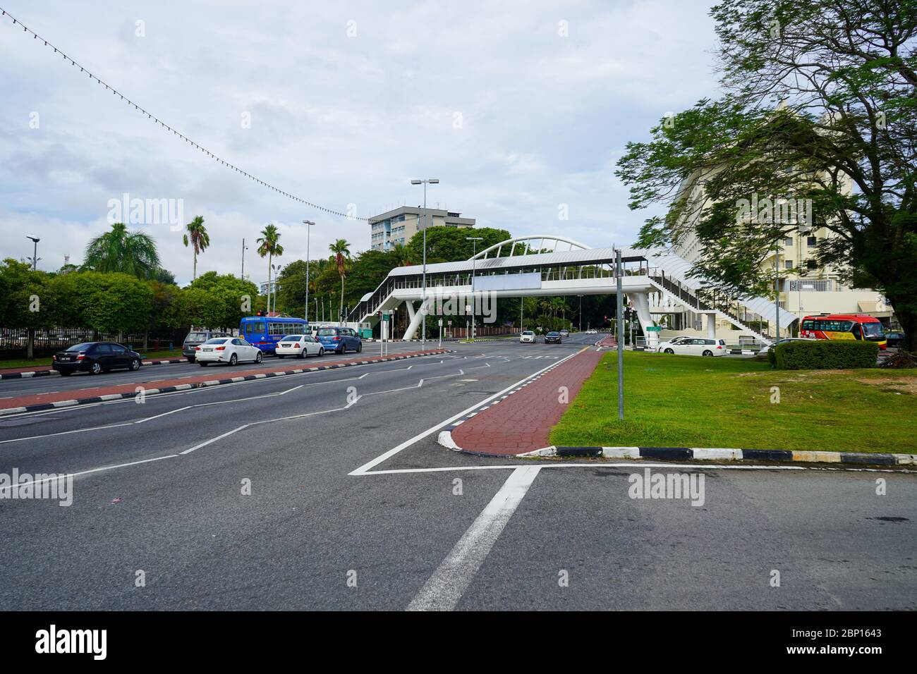 Road marks, sidewalk, overpass and different trees of Bandar Seri ...