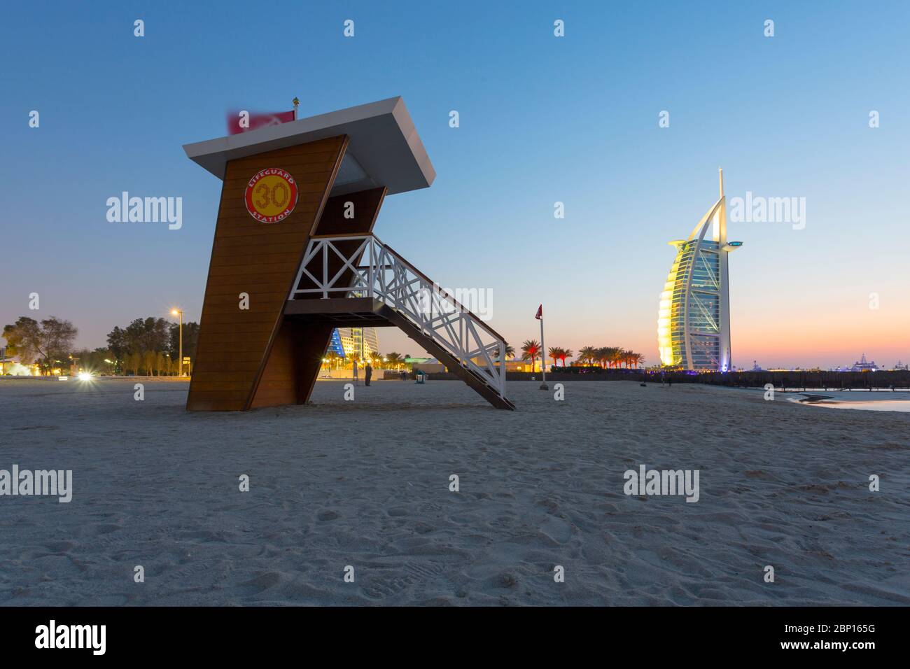 Burj Al Arab Hotel, Sunset and lifeguard watchtower on Jumeirah Beach ...