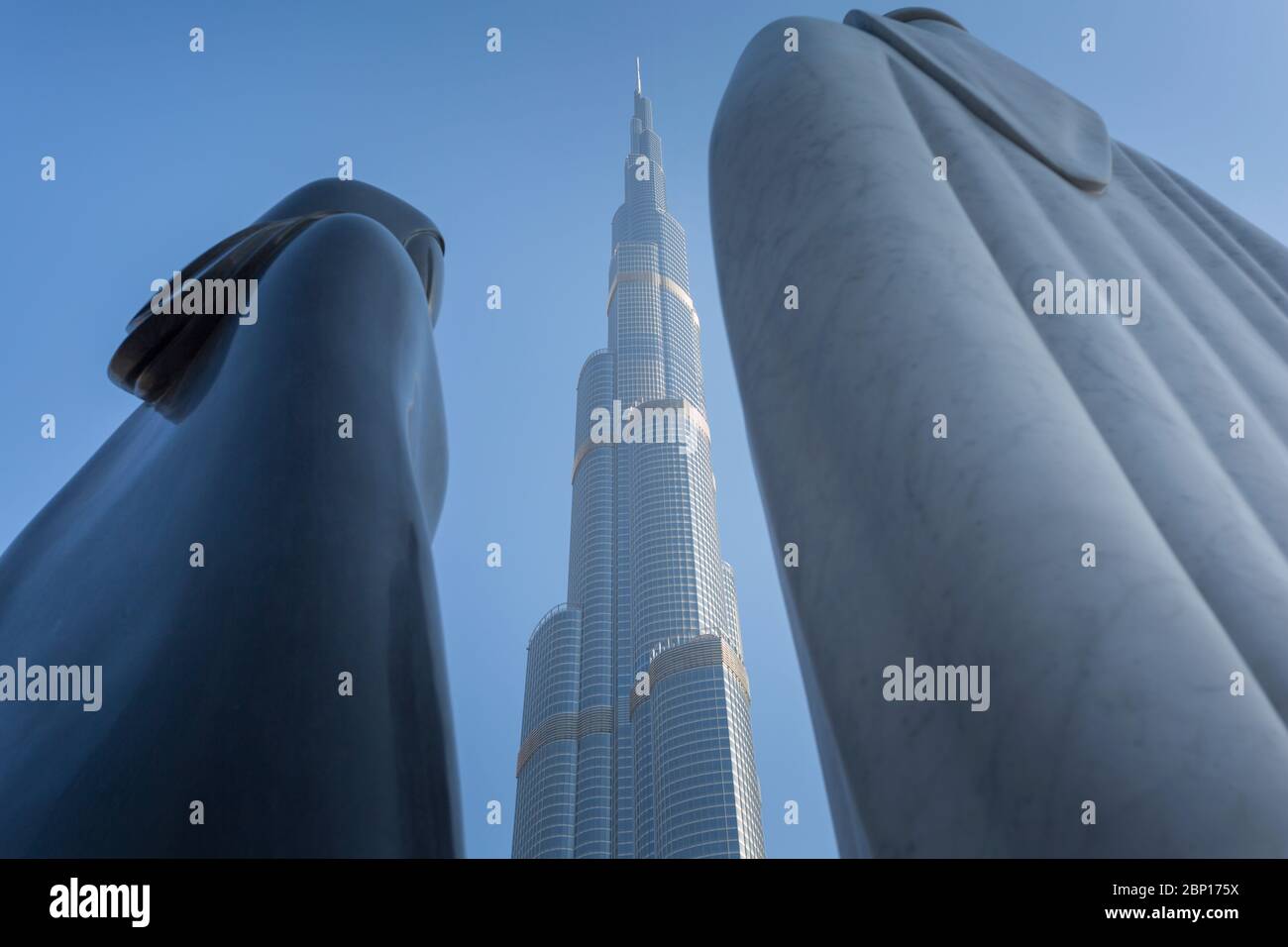 The Burj Khalifa framed by Arabic statues in Downtown, Dubai, United ...