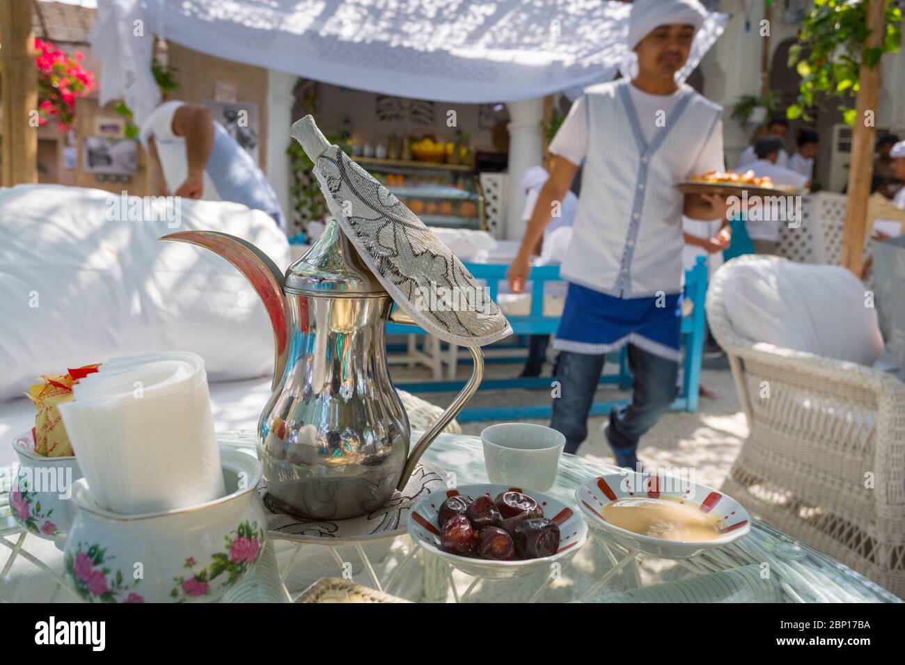 Traditional dry dates and tea and waiter in the Al Fahidi Historical ...