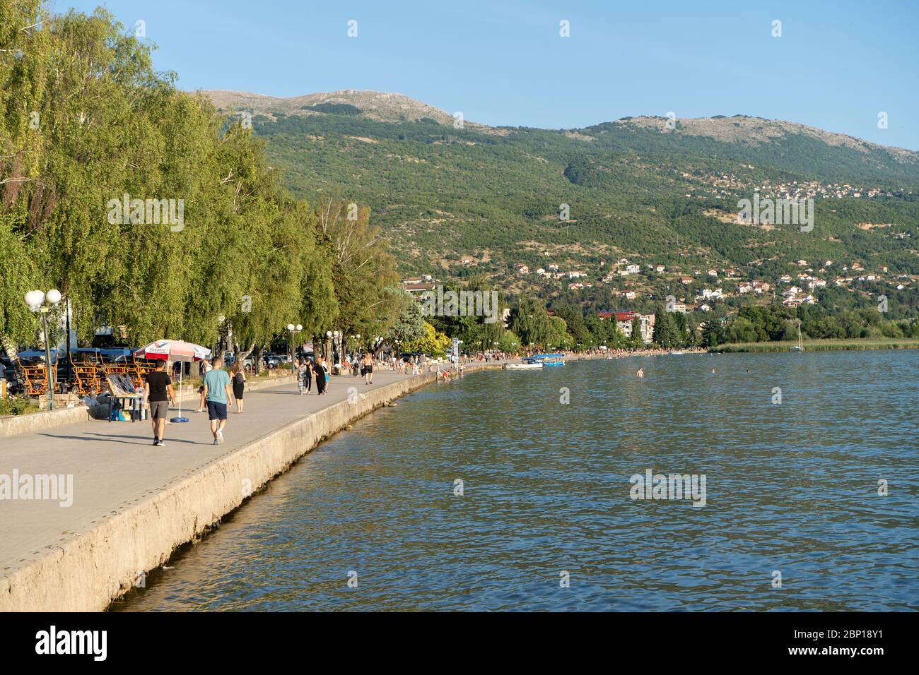 Promenade of Lake Ohrid. People are walking during the sunset. August ...