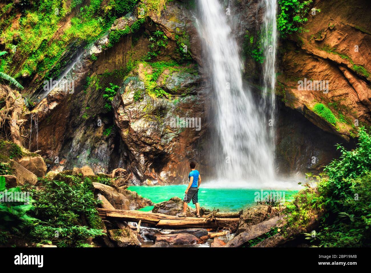 Waterfall Landscape and Traveler hands raised enjoying waterfall view ...