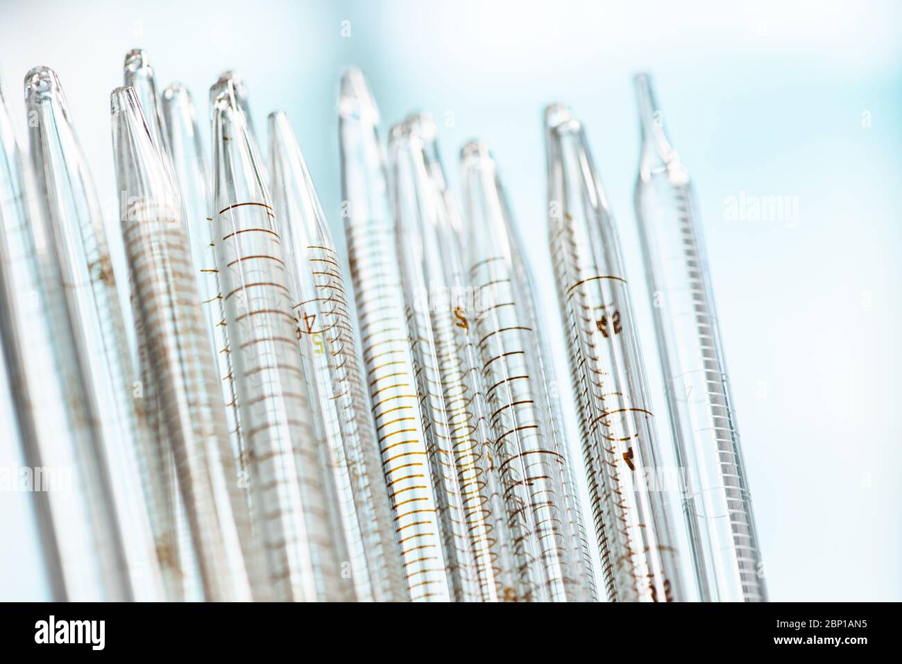 Detailed view of laboratory pipette, blurred background, vertically ...