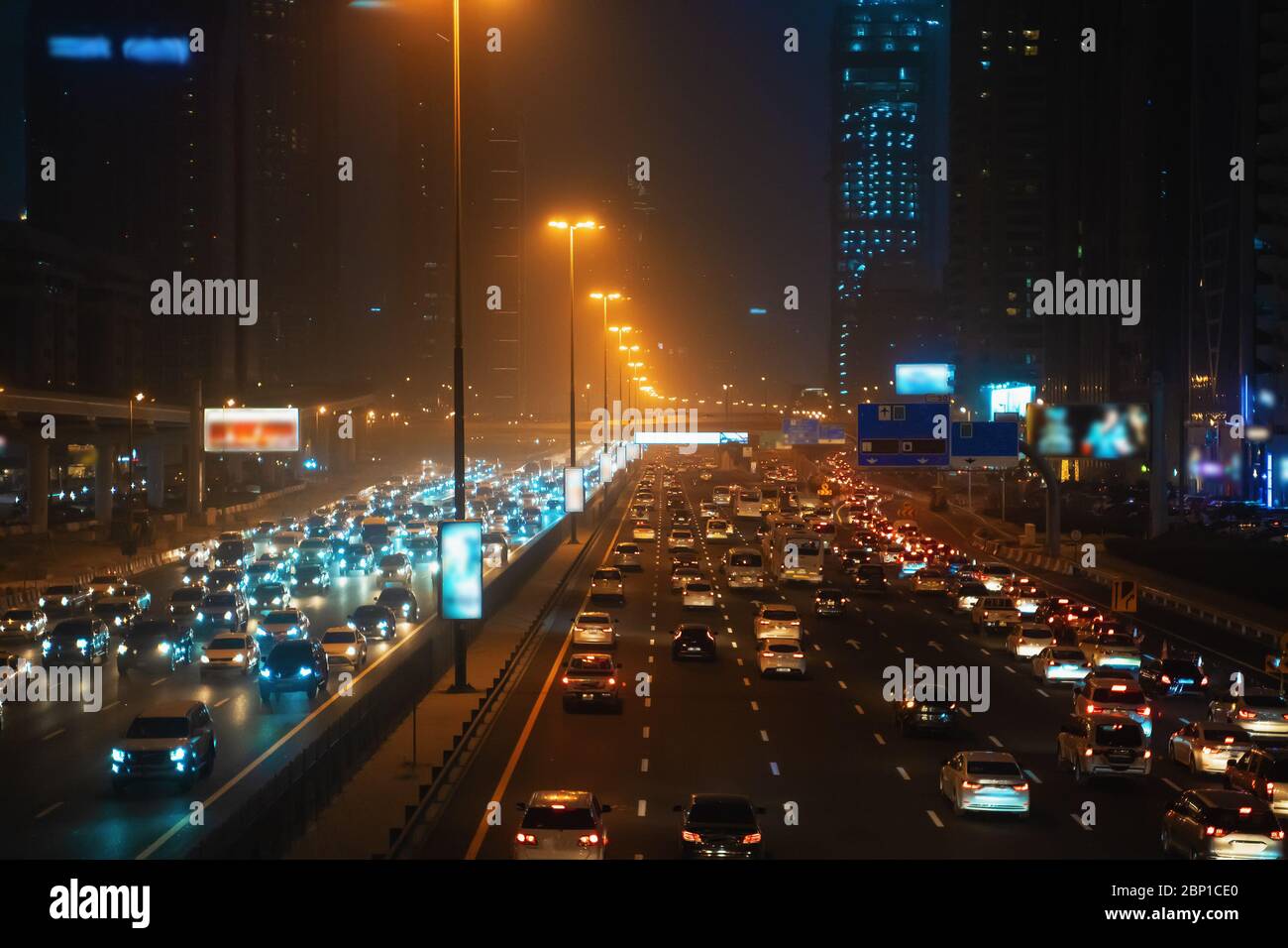 Evening rush hour with many cars on Dubai city road at night, traffic ...