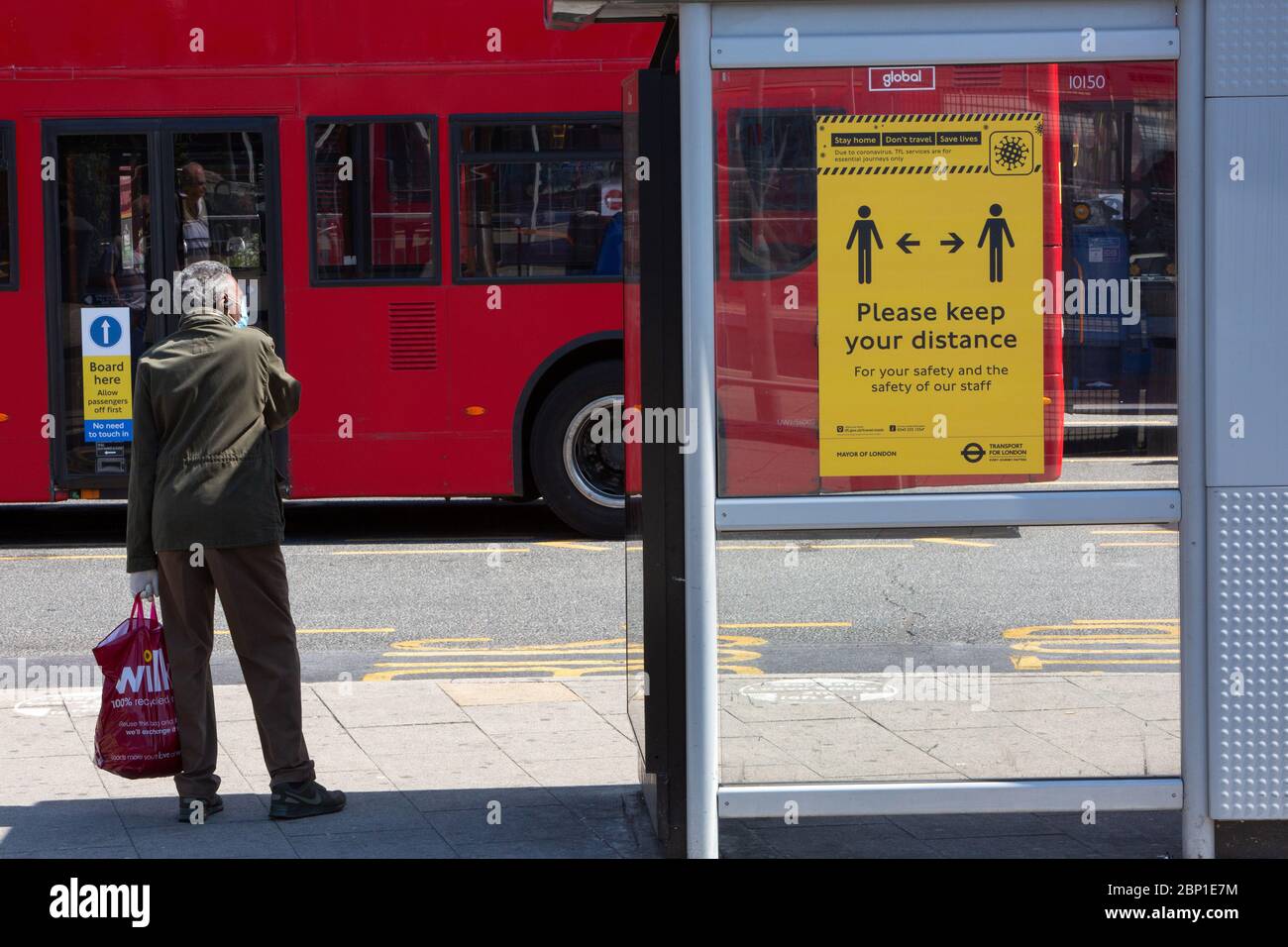 May 2020: Essential workers wait to board a double decker bus on public ...